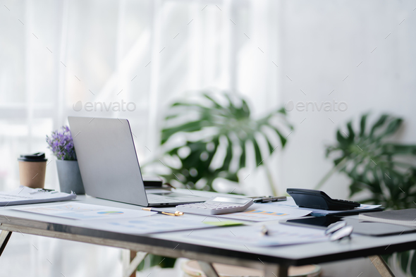 Empty workspace, no people, office desk, with laptop, calculator ...