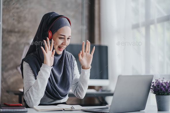 Muslim female fighter studying online and greeting video call smiling ...