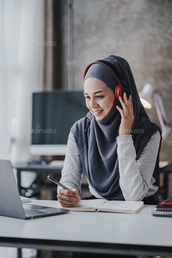 Muslim female fighter studying online and greeting video call smiling ...