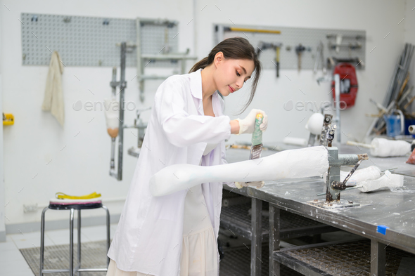 Prosthetic technician sculpting plaster cast for socket at factory Stock Photo by 1footage