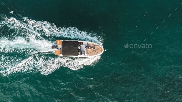Speed boat sailing with high speed in the ocean Stock Photo by wirestock