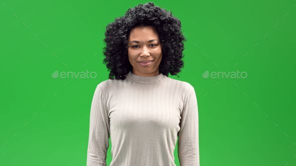 Young black African American female with a curly afro smiling on a ...