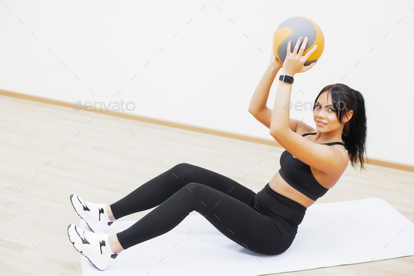 Fitness woman. Young attractive woman doing exercises using ball Stock ...
