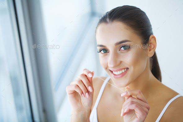 Dental Health. Woman With Beautiful Smile Flossing Healthy Teeth. High ...