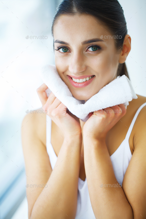 Face Washing. Happy Woman Drying Skin With Towel Stock Photo by maksymiv