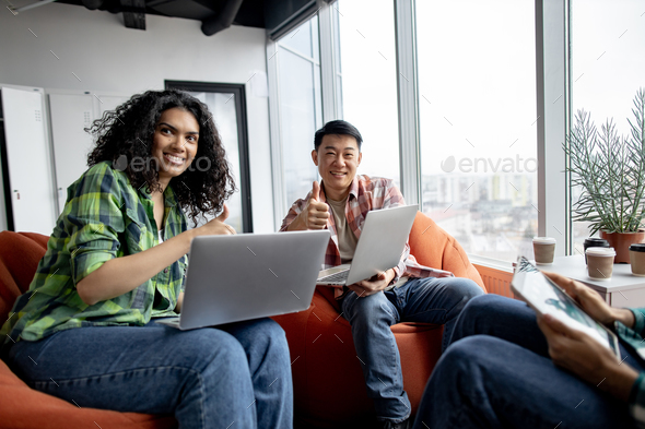 Fellow workers looking at computer screen in office interior Stock ...