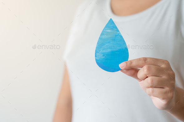 Hands holding a paper water drop element in a concept of Water ...