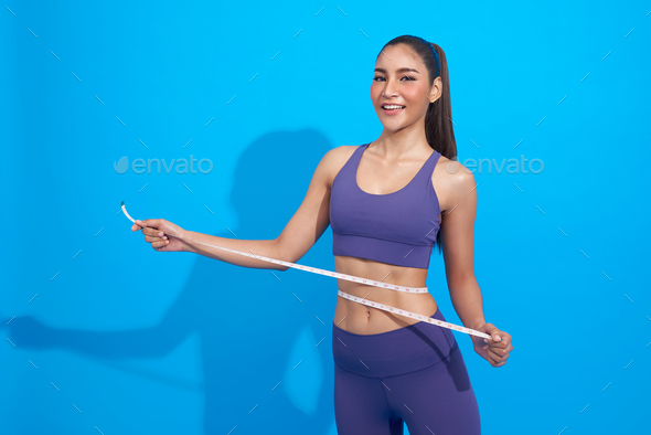 happy smiling asian fitness woman with slim body measuring her ...