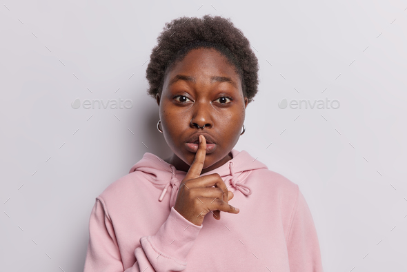 Photo of mysterious dark skinned woman ready to tell secret makes shush ...