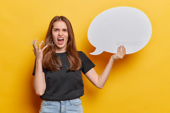 Angry outraged woman gestures with irritation has argument with someone ...