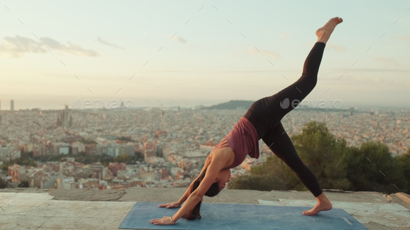 Girl practices handstand yoga asana at lookout point at dawn Stock ...