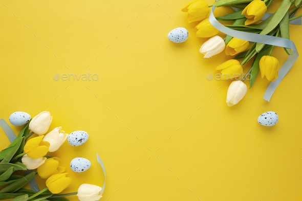 Yellow Easter background with beautiful tulip flowers and speckledeggs ...