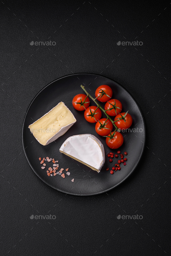 Delicious fresh brie cheese in the form of a mini head with cherry ...