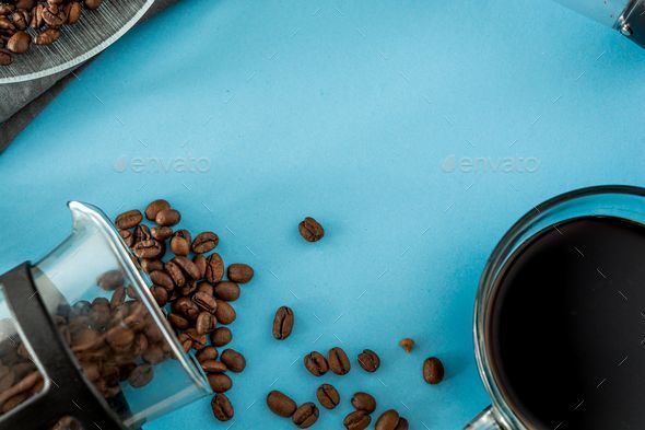 coffee beans and elements over blue background Stock Photo by wirestock