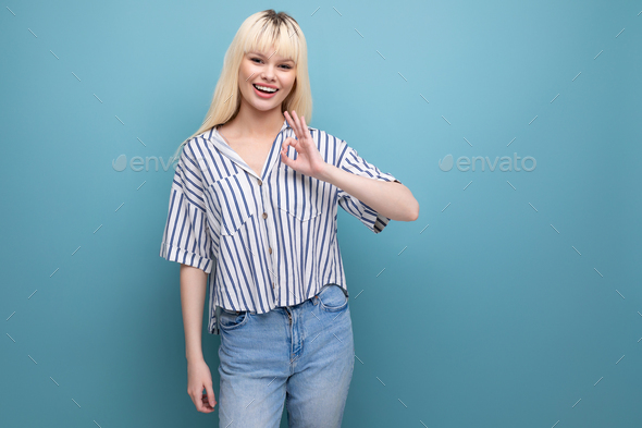 Cheerful cute blond 25 year old female person in a striped blouse and ...