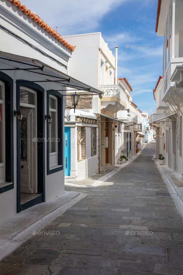 Greece, Cyclades. Andros island, Chora town. Empty alley white wall ...