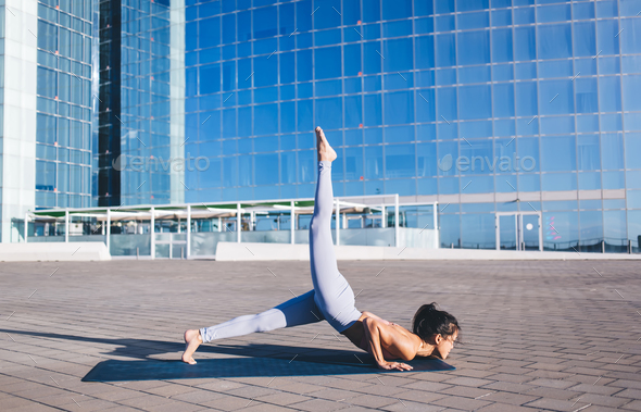 Active Asian female yogi with slim body enjoying healthy lifestyle ...