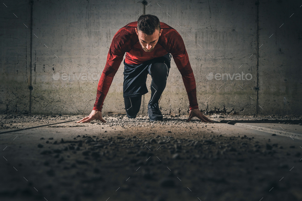 Athlete in a low start pose, starting a race Stock Photo by ...