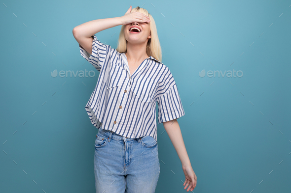 Cheerful cute blond 25 year old female person in a striped blouse and ...