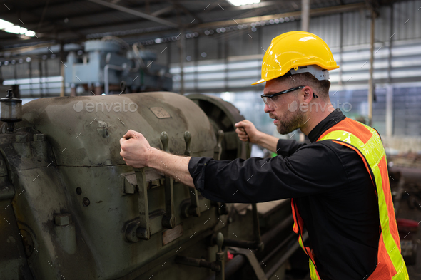 Mechanical engineers enter the old machinery warehouse to inspect and ...