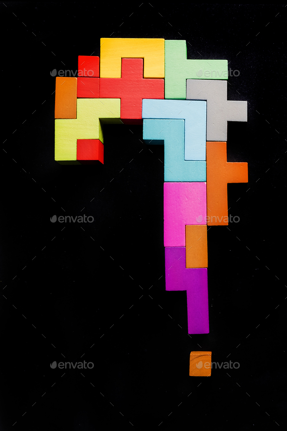 question mark wooden blocks on black background. Geometric shapes in ...