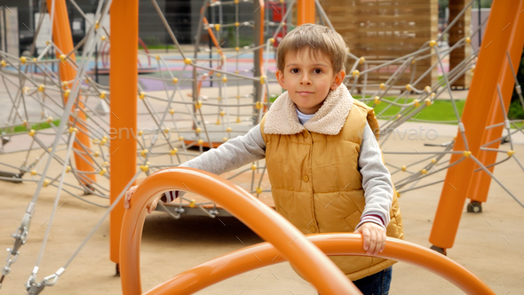 Happy smiling boy spinning on carousel at the public playground Stock ...