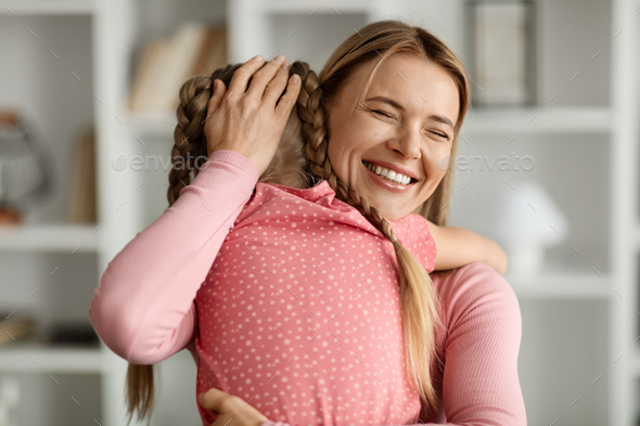 Mother Daughter Love. Happy Woman Hugging Her Little Child At Home Stock Photo by Prostock-studio