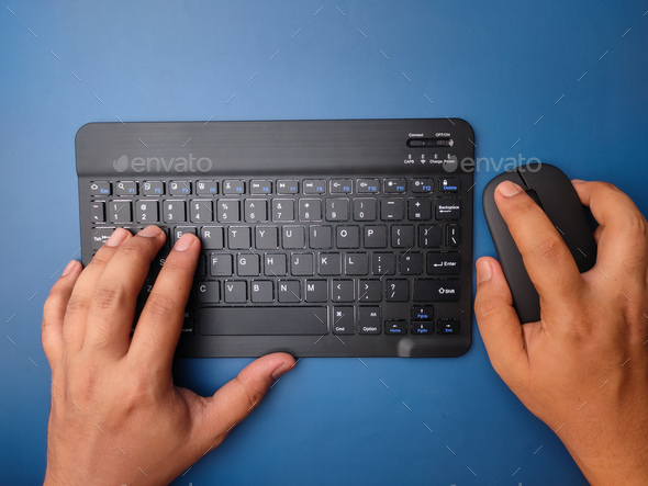 Top view someone hand typing wireless keyboard with holding mouse on ...