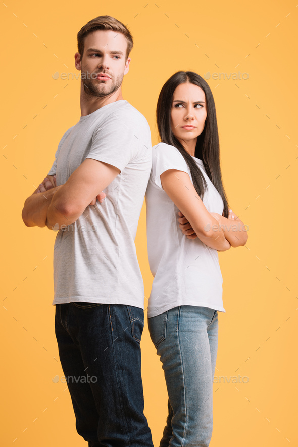 offended couple standing back to back with crossed arms, isolated on ...