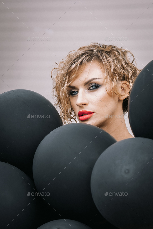 Portrait beautiful woman of model appearance with dark balloons. Art ...