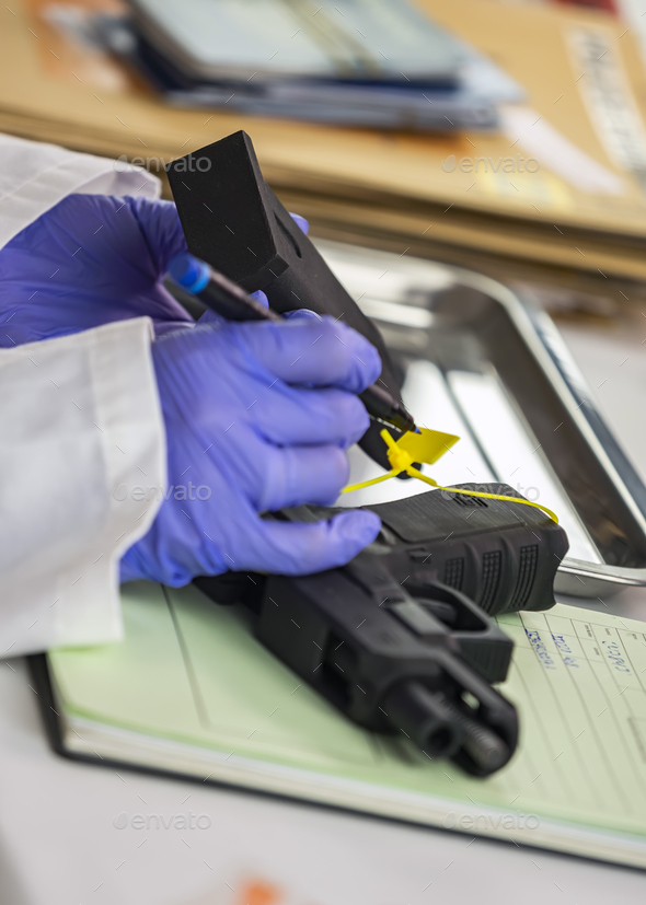 Police scientist writes serial number on firearm magazine in crime lab ...