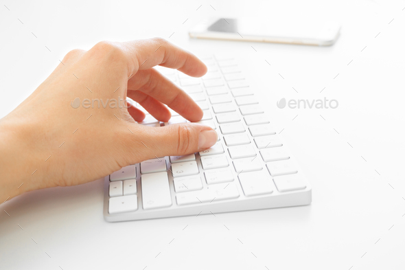 Woman's hands using keyboard at the office Stock Photo by FabrikaPhoto