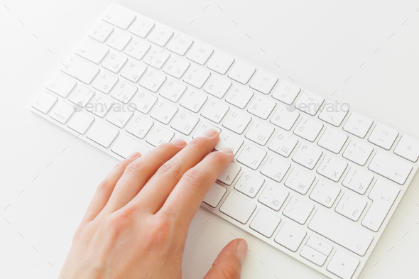Woman's hands using keyboard at the office Stock Photo by FabrikaPhoto