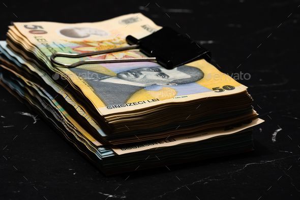Stack of Romanian LEI banknotes and a binder clip Stock Photo by wirestock