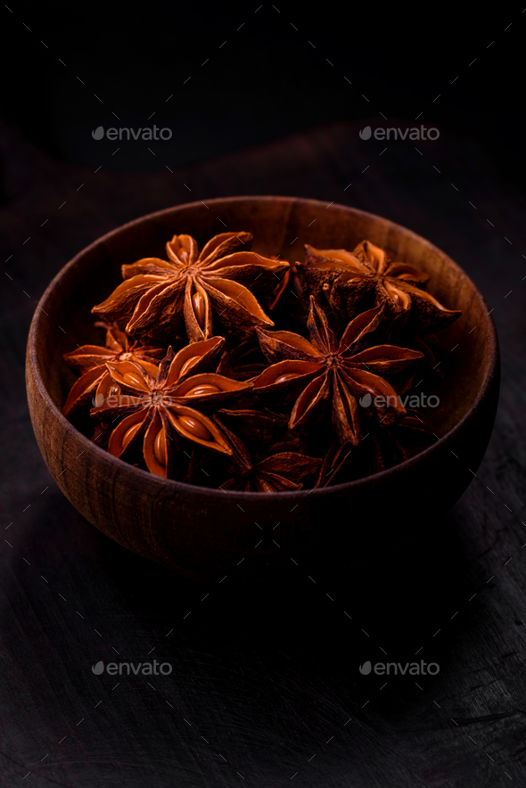 Star shaped spice star anise in a wooden round bowl Stock Photo by ...