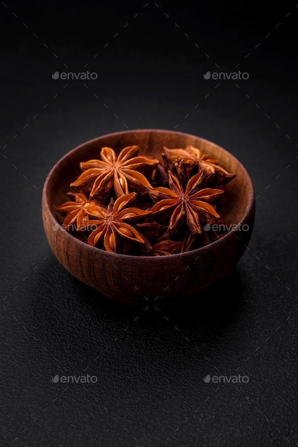 Star shaped spice star anise in a wooden round bowl Stock Photo by ...