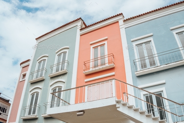The facades of the pastel-colored buildings with Portuguese ...