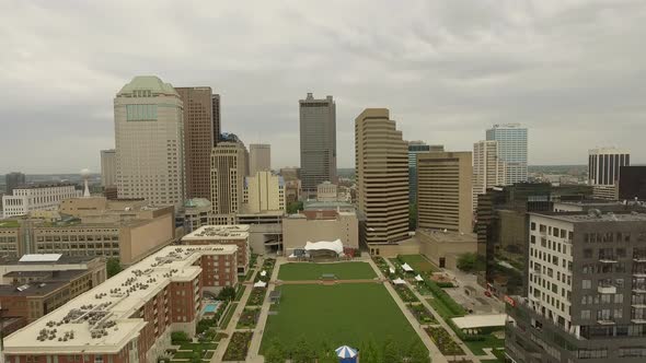 Rising drone shot of the John F. Wolfe Columbus Commons and Columbus ...