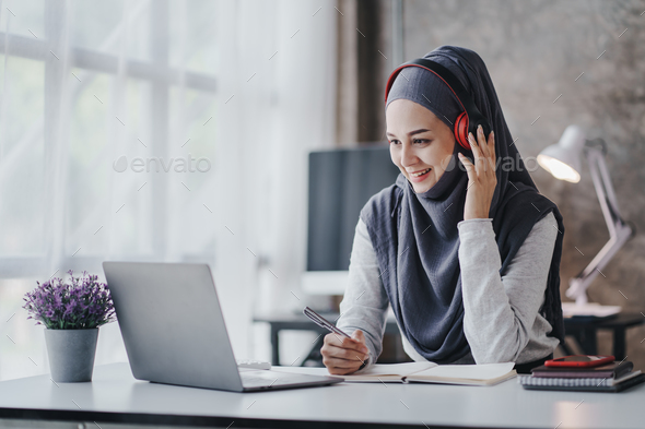 Muslim female fighter studying online and greeting video call smiling ...