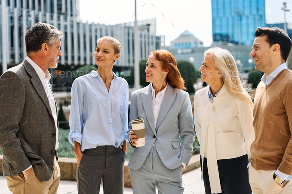 Group of business people talking and drinking coffee outdoors Stock ...