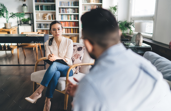 Psychologist asking questions to client Stock Photo by GaudiLab | PhotoDune