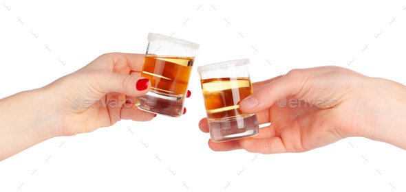 Two hands clinking shots of alcoholic beverage together Stock Photo by ...