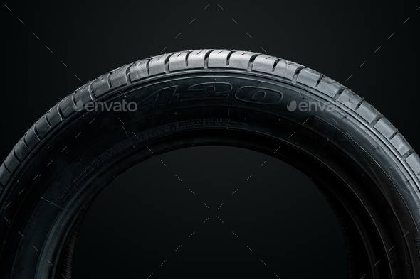 Brand new modern car tyre on a black background. Studio shot Stock ...