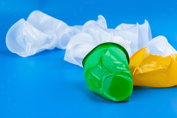 Disposable colored plastic cups garbage. Garbage and pollution concept ...