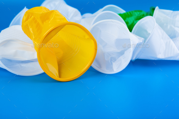 Disposable colored plastic cups garbage. Garbage and pollution concept ...