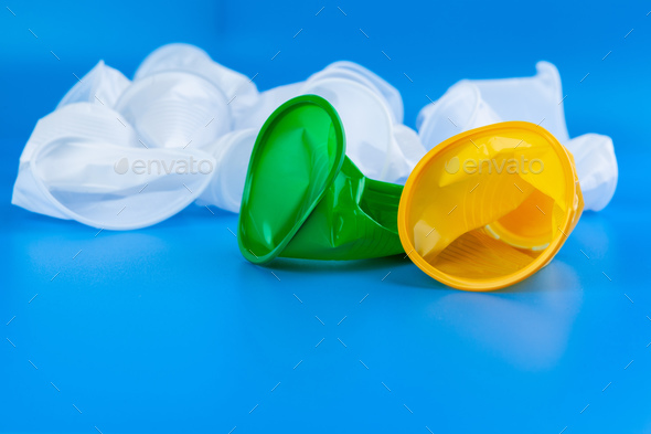 Disposable colored plastic cups garbage. Garbage and pollution concept ...