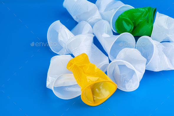 Disposable colored plastic cups garbage. Garbage and pollution concept ...
