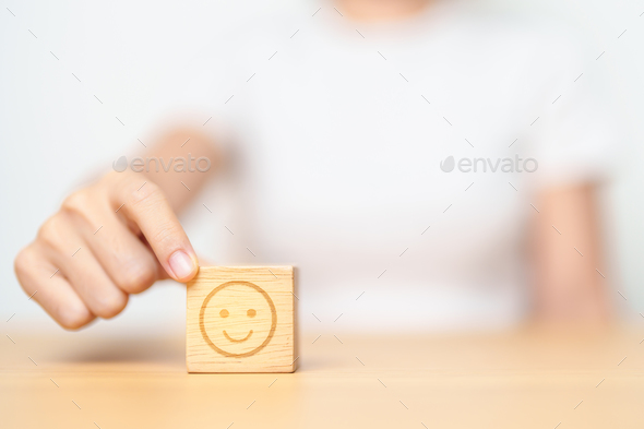 Hand choosing happy face from Emotion block Stock Photo by JoPanwatD