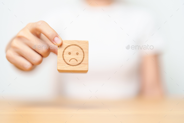 Hand choosing unhappy angry face from Emotion block. Stock Photo by ...
