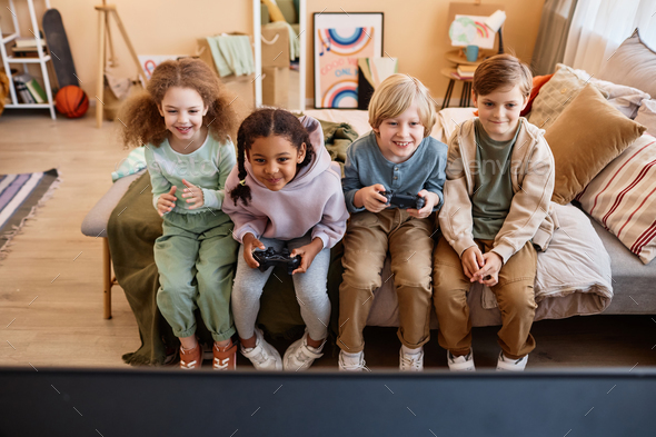 Group of little children playing video games and having fun Stock Photo ...